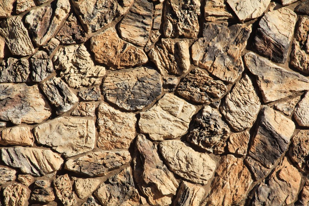 Stone Texture rock wall jagged rough brown masonry stock image - Texture X