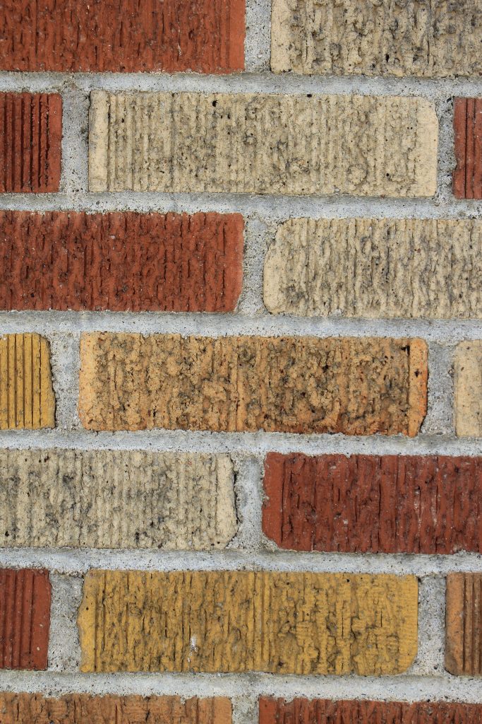 brick texture multi colored red yellow orange close up photo - Texture X